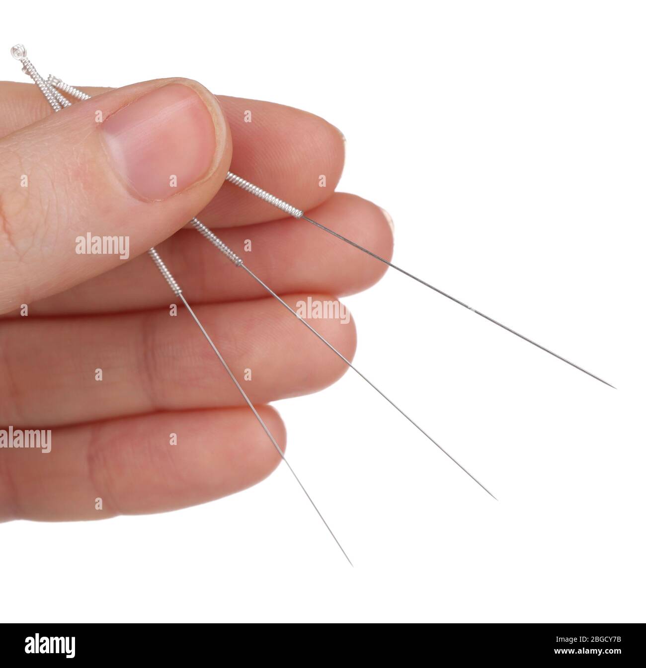 Hand holding needles for acupuncture on hand, close up. Isolated on ...