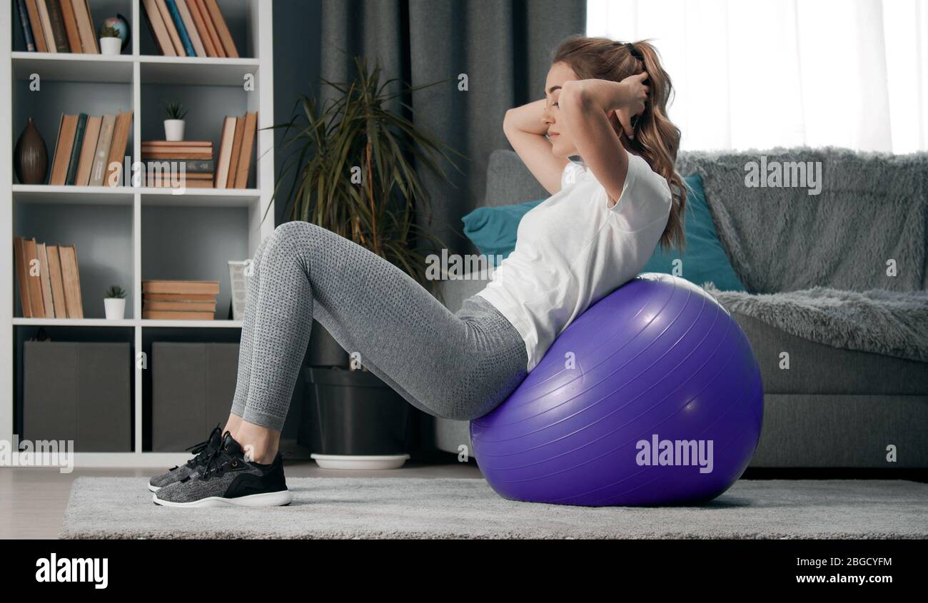 Woman leaning backwards on fitball Stock Photo - Alamy