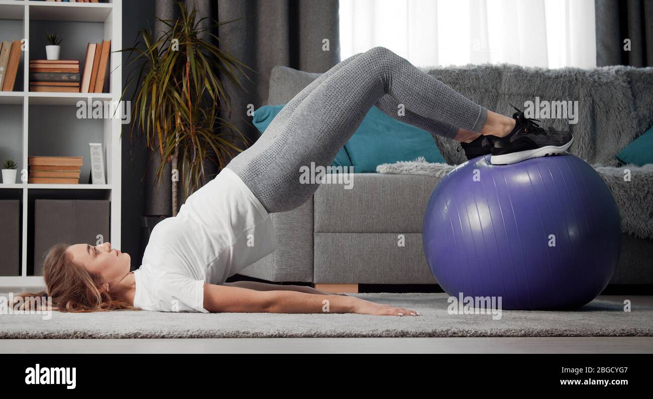 Female doing bridge using fitball Stock Photo - Alamy