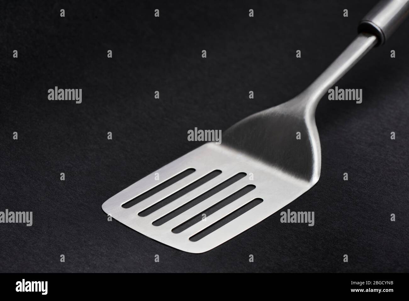 spatula on dark background Stock Photo - Alamy