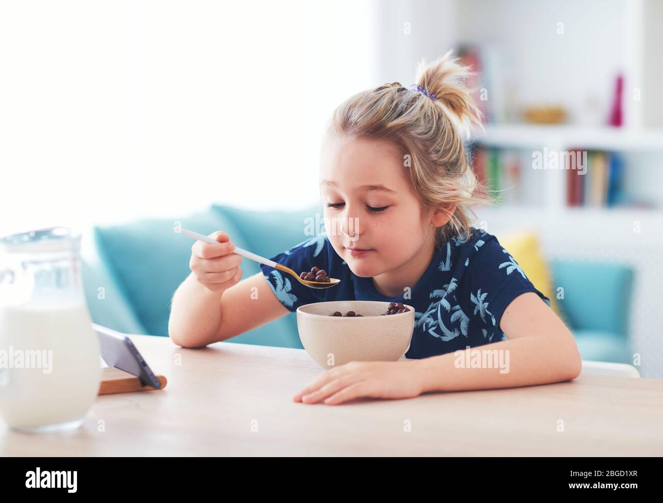 cute young boy is eating breakfast in the morning Stock Photo - Alamy