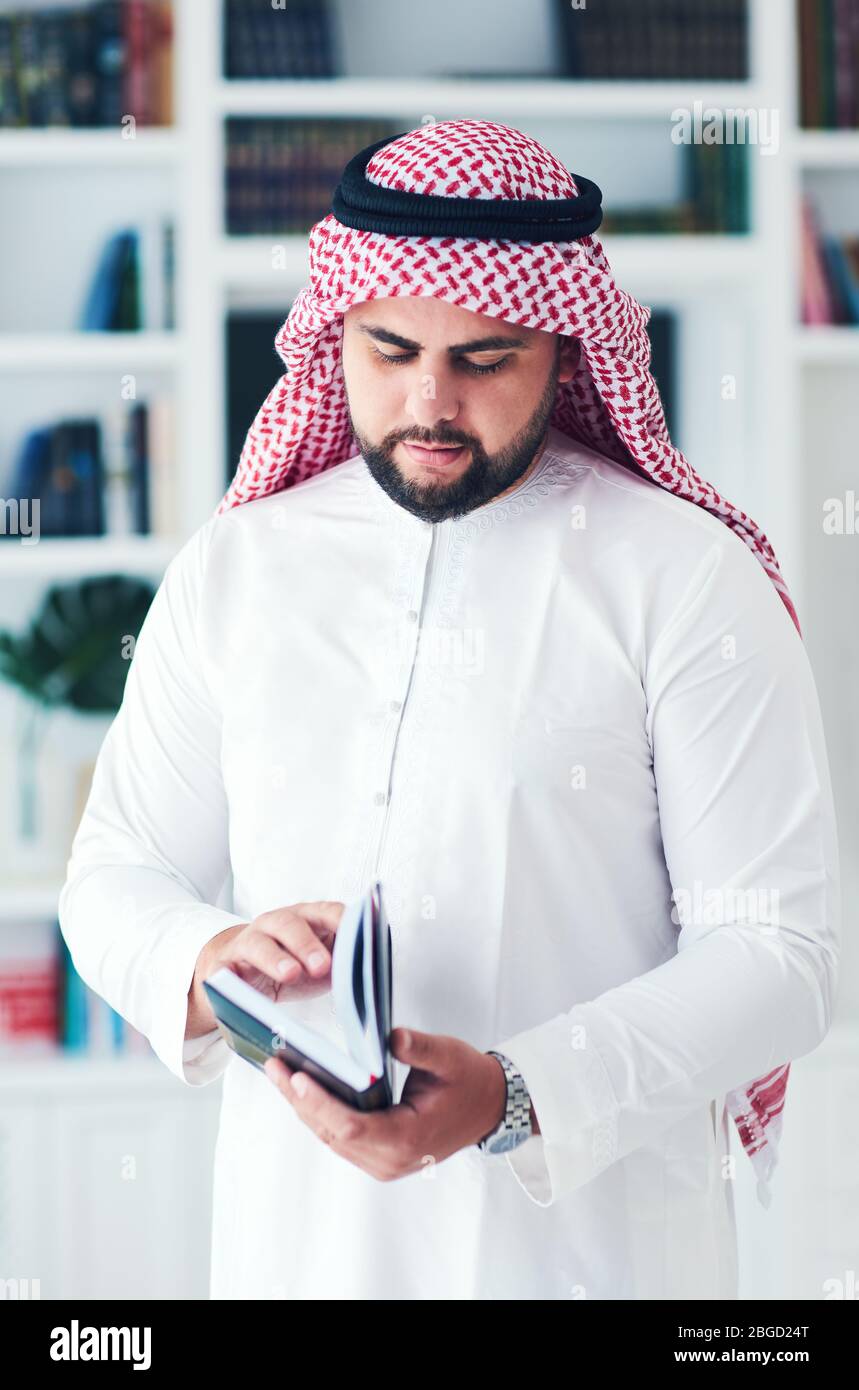 young adult muslim man reading book indoors Stock Photo - Alamy