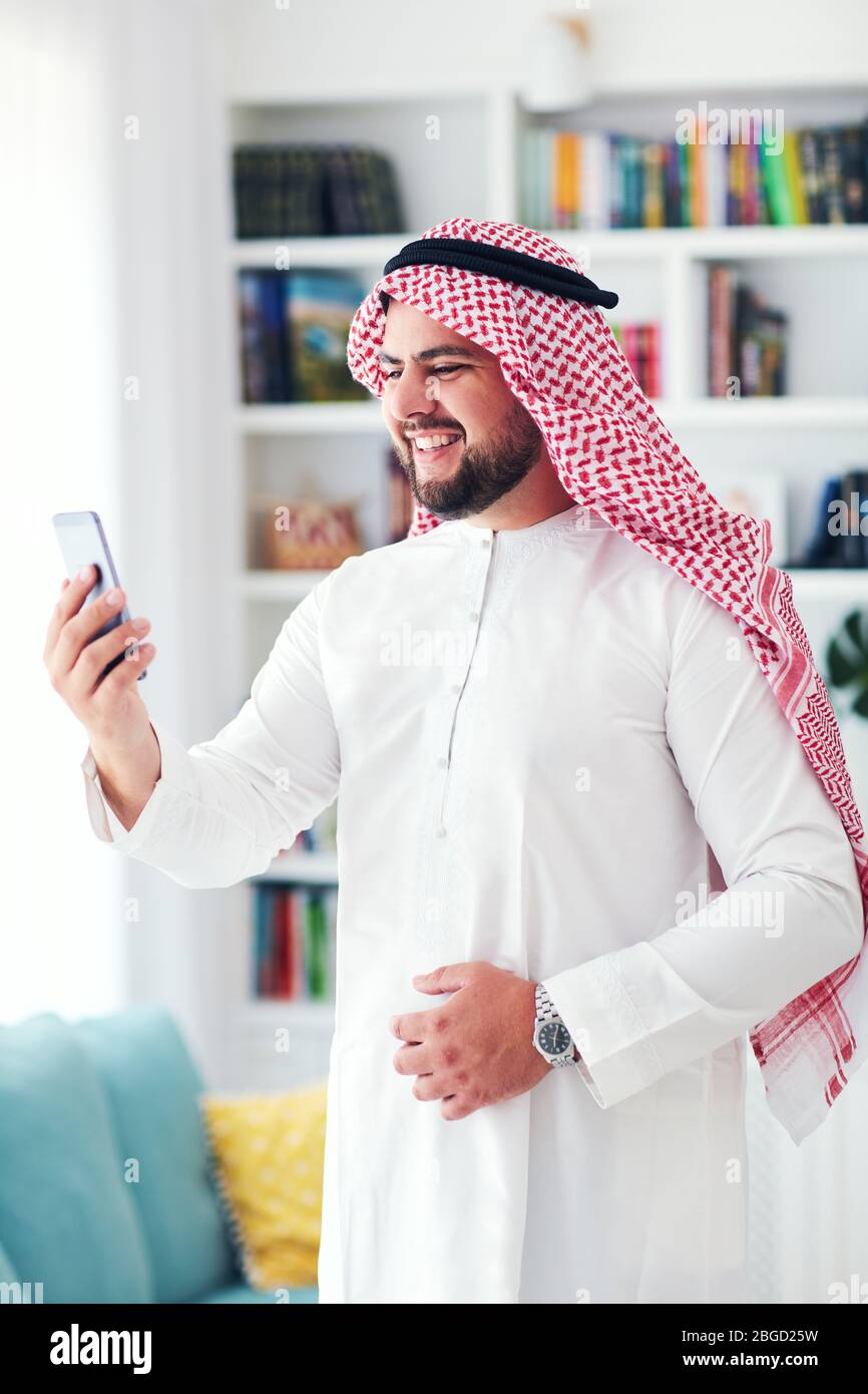 smiling arab man talking by video conference at home Stock Photo - Alamy