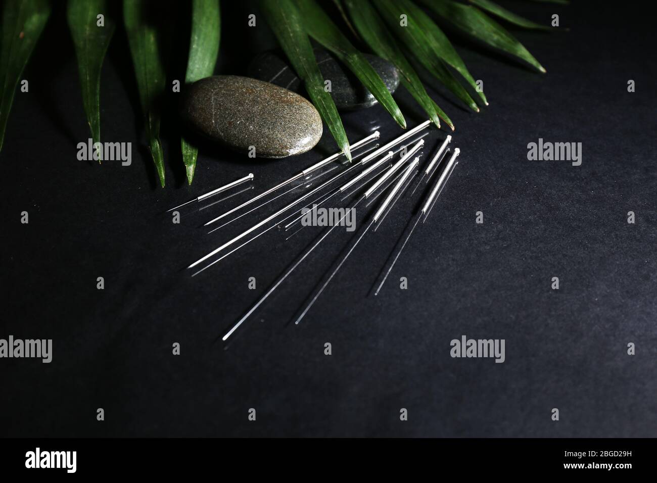 Acupuncture needle on black stone hi-res stock photography and images ...