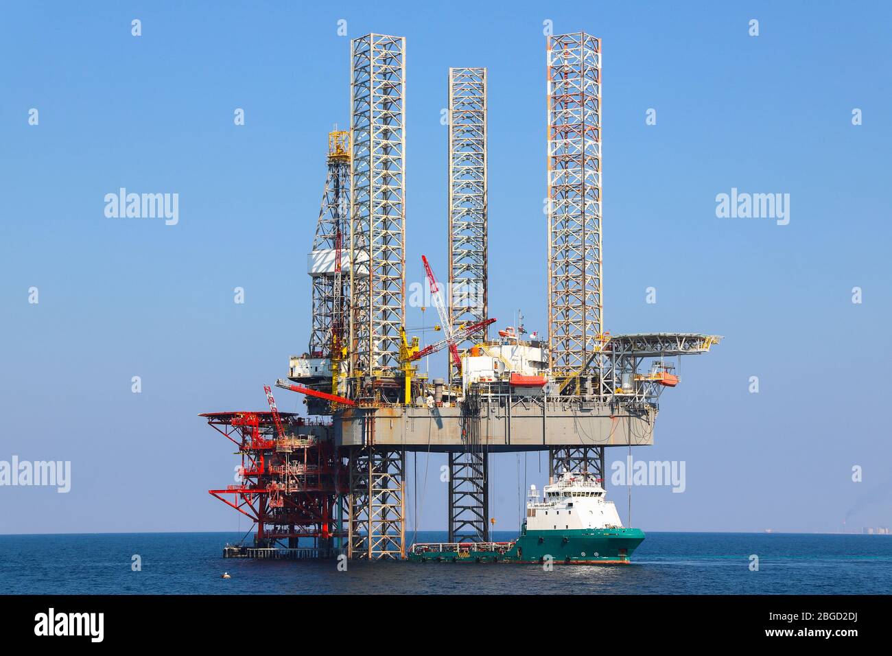 Offshore oil platform and supply ship are in Persian Gulf. United Arab ...