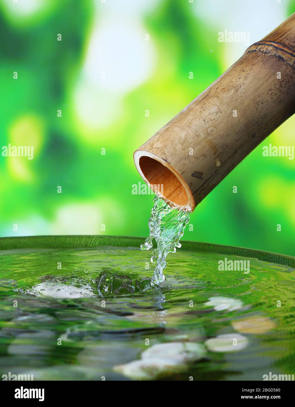 Spa still life with bamboo fountain, on bright background Stock Photo ...
