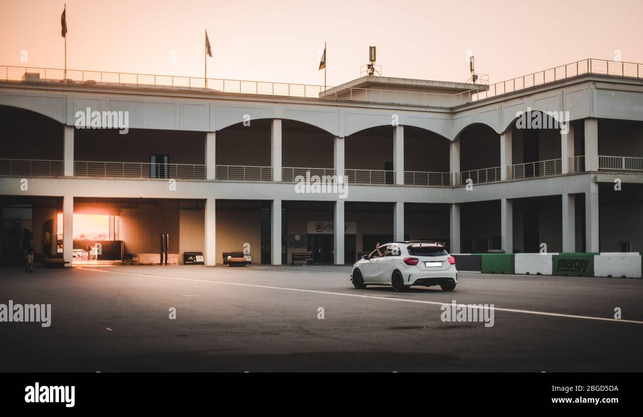 White sport car in front of a business building Stock Photo - Alamy