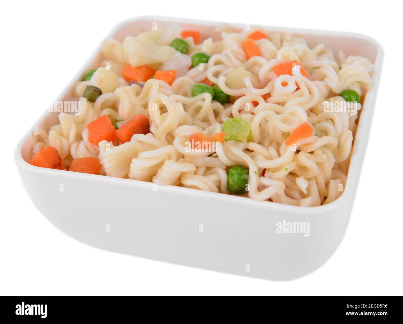 Tasty instant noodles with vegetables in bowl isolated on white Stock ...