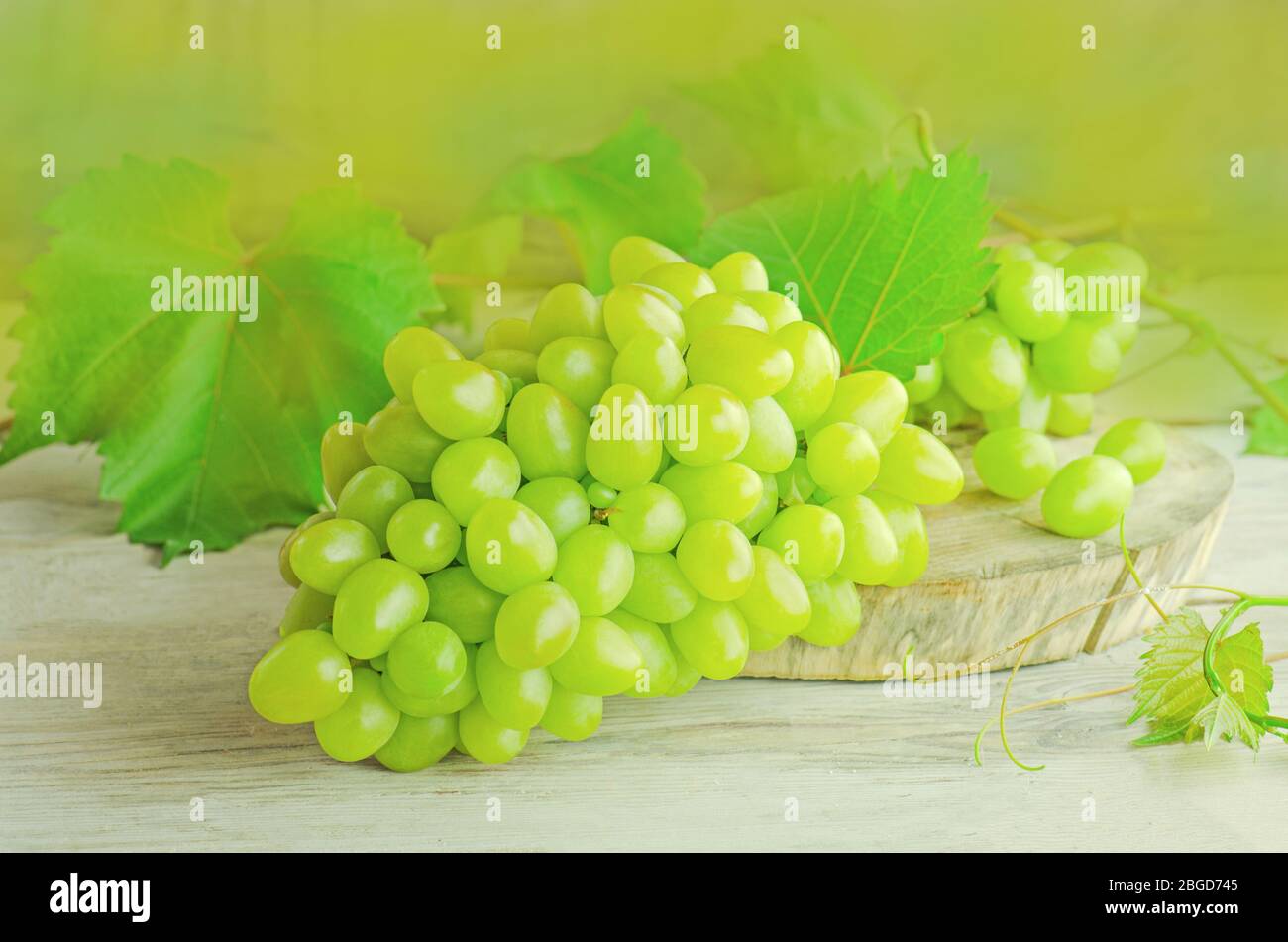 Sweet green grape over the wooden background. Fresh green grapes. Bunch ...