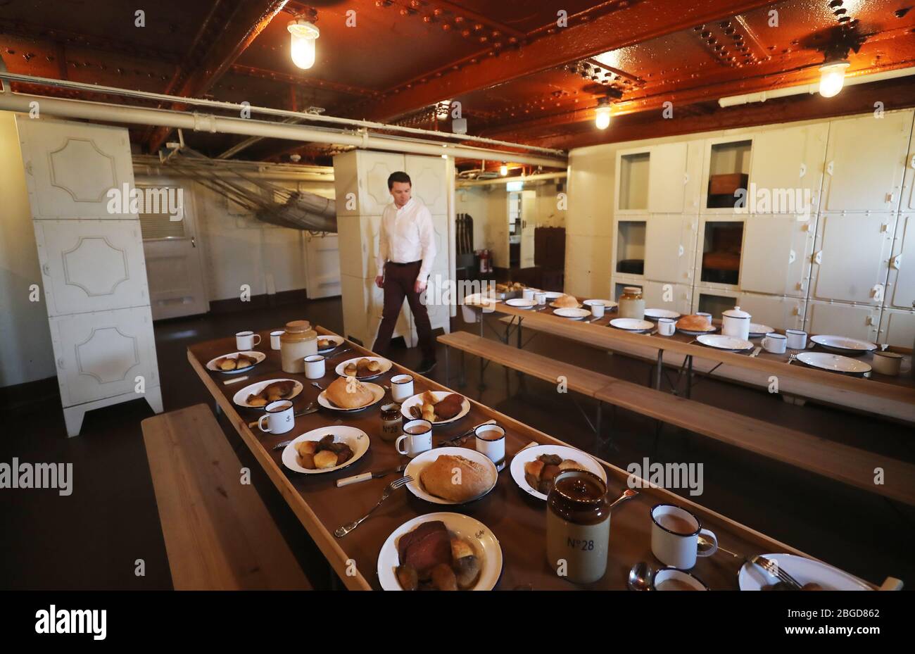 Manager Ben Robson checks on the sailors' mess aboard the HMS Caroline ...