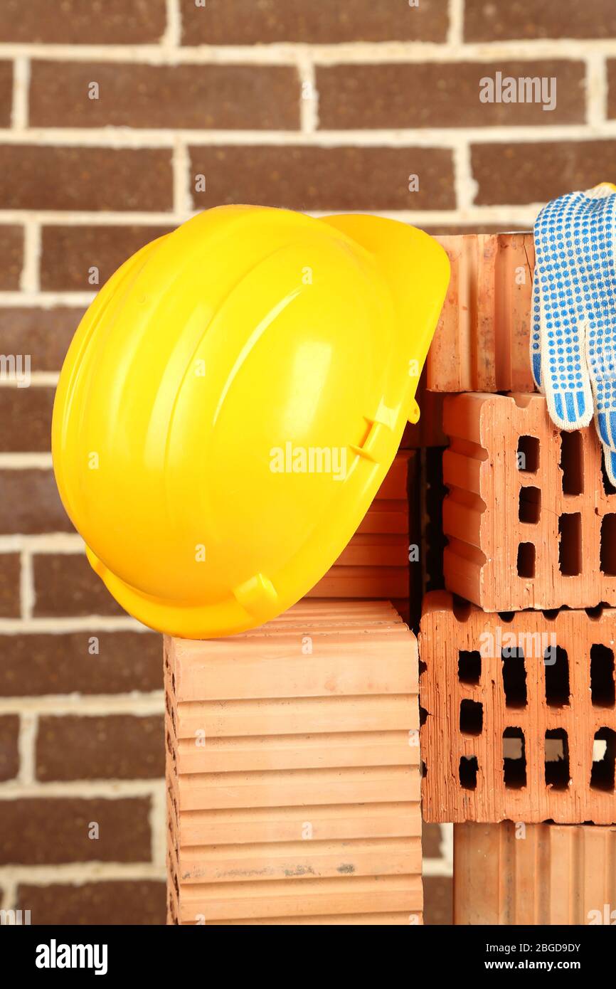 New bricks and building tools on brick wall background Stock Photo - Alamy