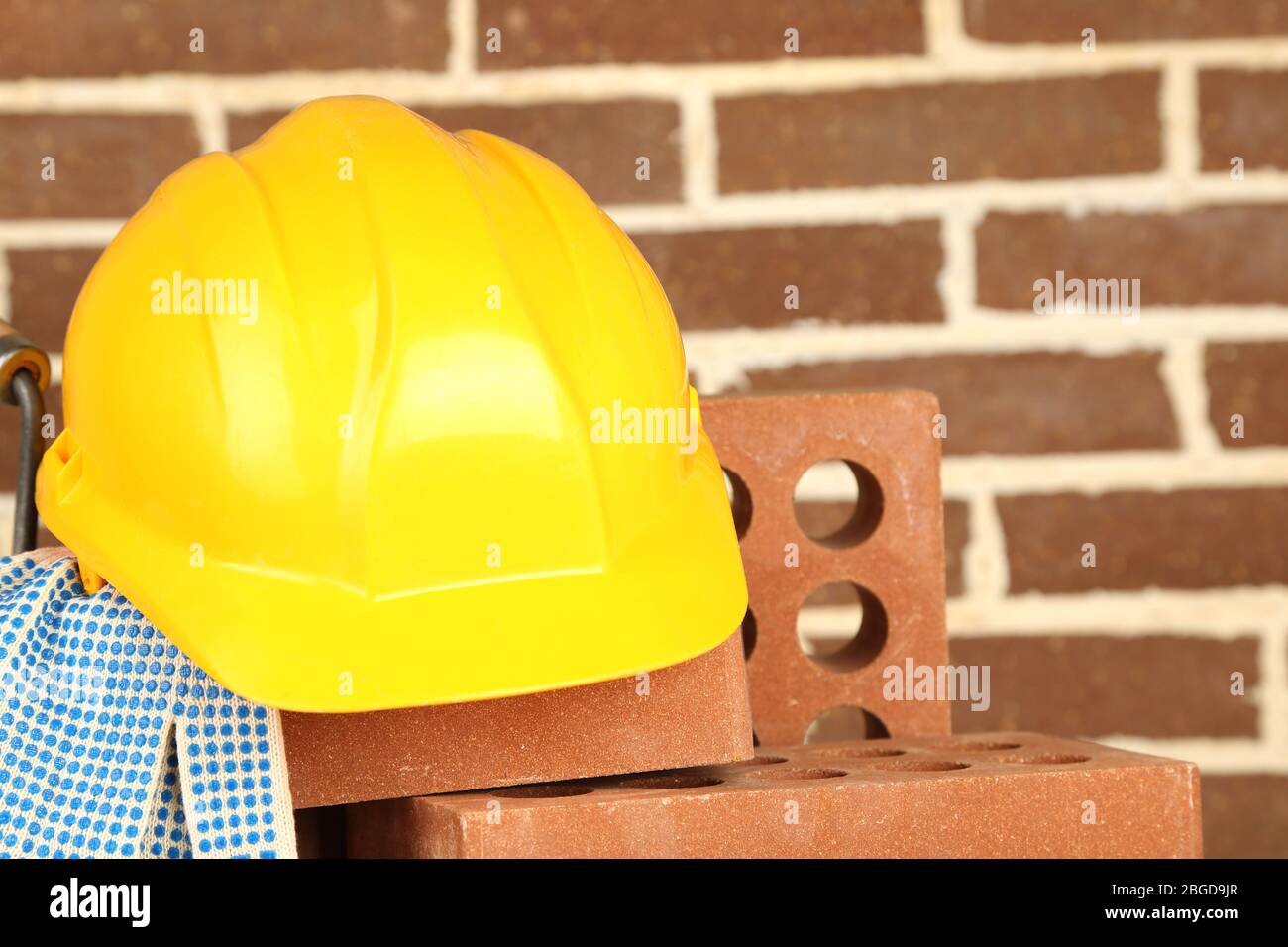 New bricks and building tools on brick wall background Stock Photo - Alamy