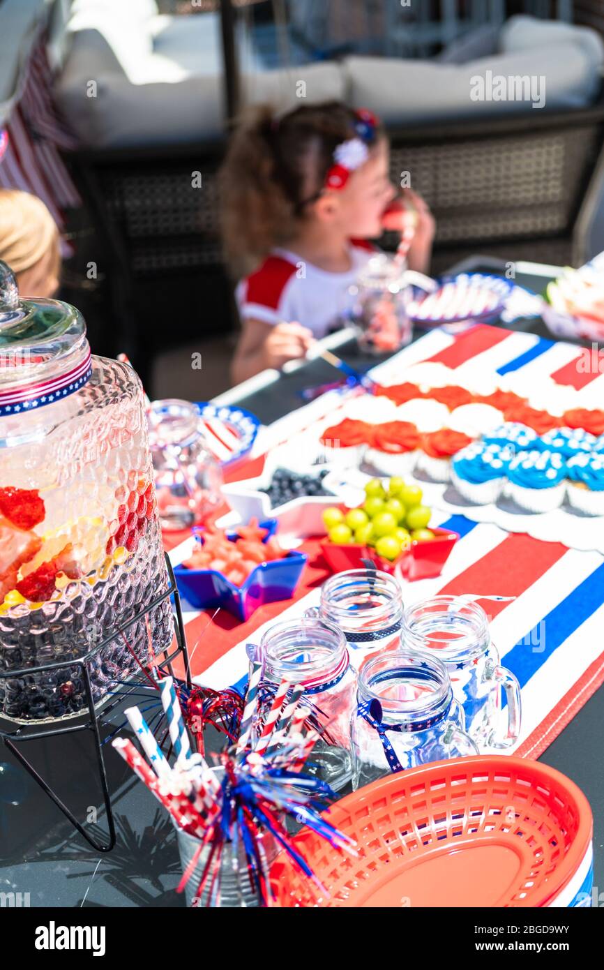Little girls are playing at the July 4th party on the back patio Stock ...