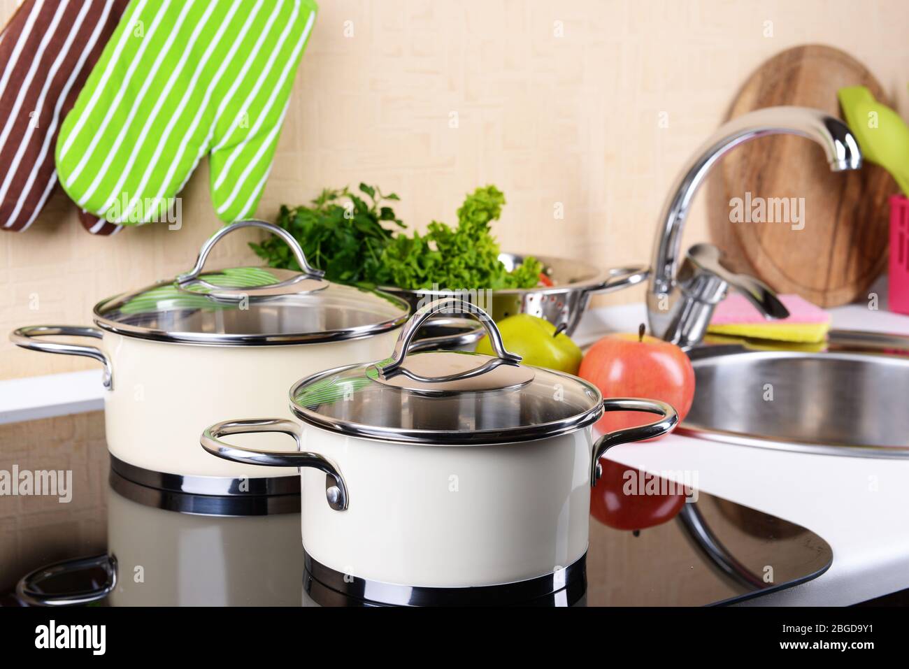 Pots on stove in kitchen Stock Photo - Alamy