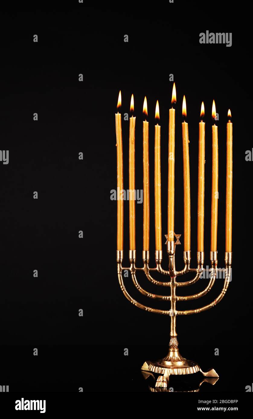 Candles burning on golden menorah hi-res stock photography and images ...
