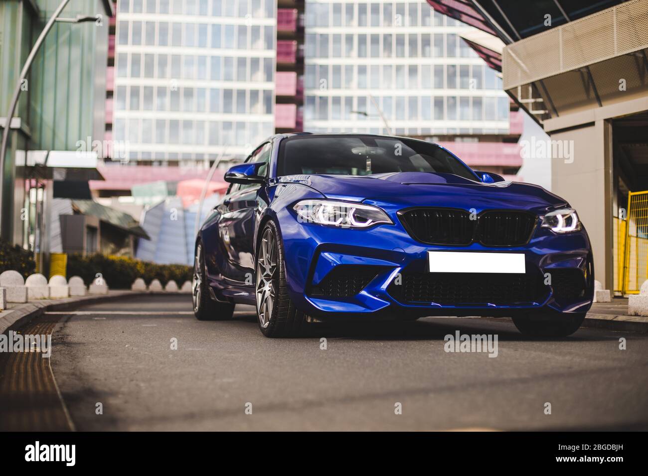Blue design racing car in front of a performance center Stock Photo - Alamy