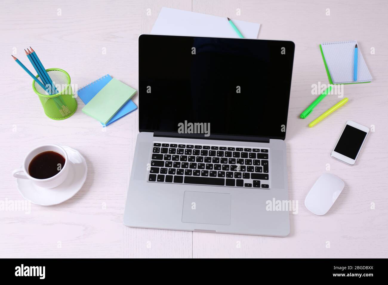 Office workplace with open laptop on wooden desk Stock Photo - Alamy