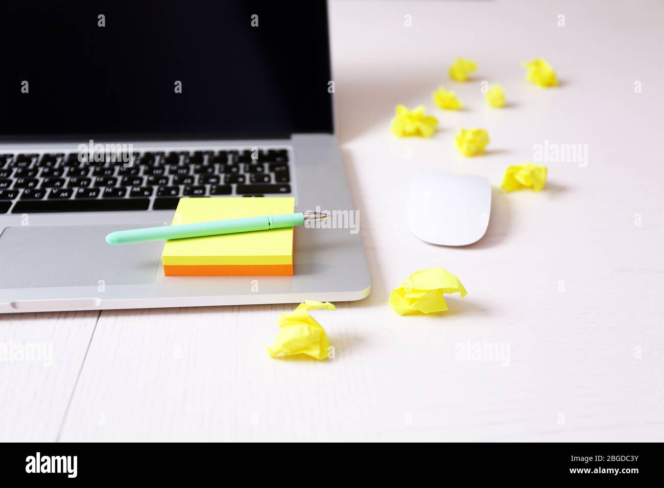 Office workplace with stickers and laptop on wooden desk Stock Photo ...