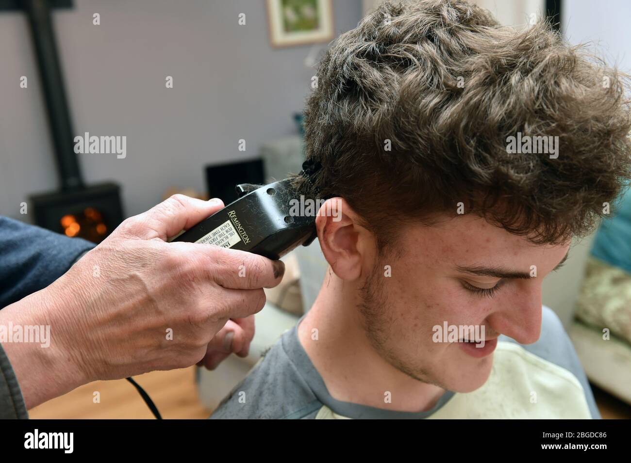 Life in coronavirus lockdown in the UK April 2020. Father cutting his ...