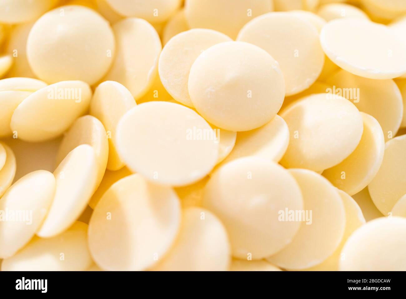 White round chocolate chips for melting chocolate shapes on a white ...