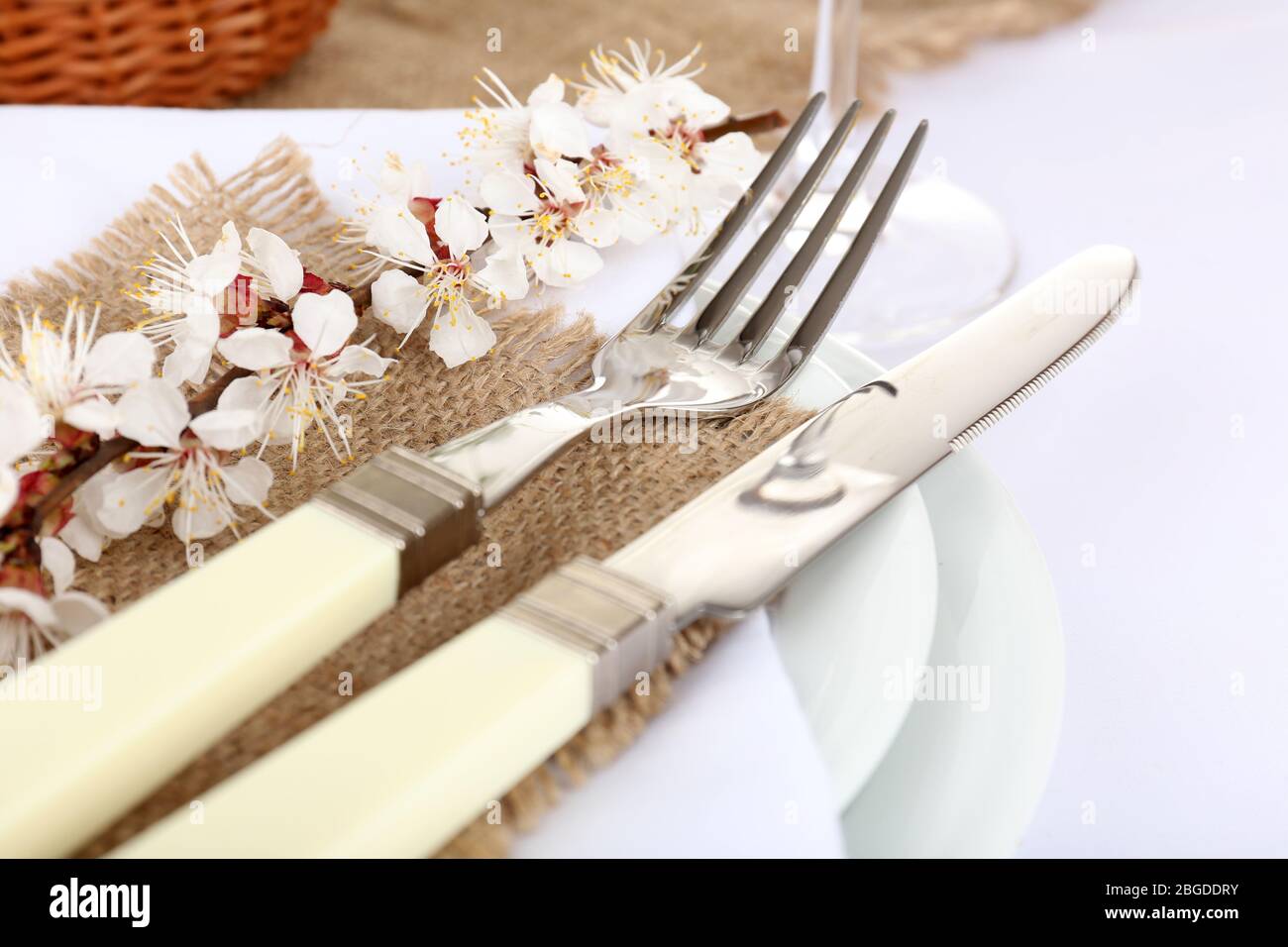 Table setting with spring flowers close up Stock Photo - Alamy