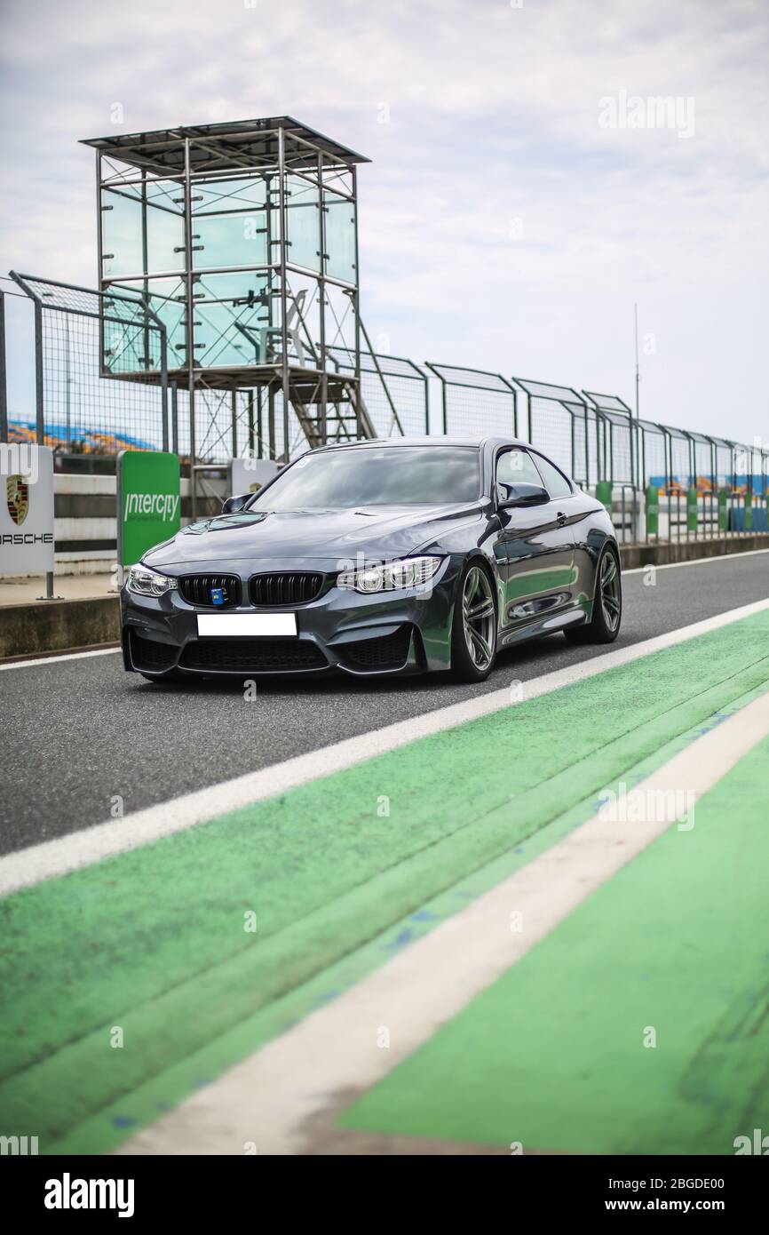 Black sport car in a racing stadium track Stock Photo - Alamy