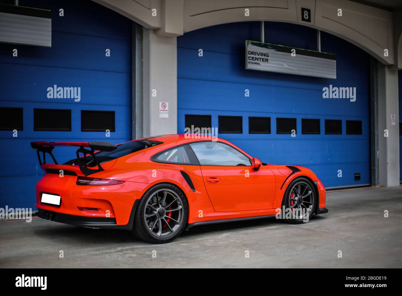 Orange color racing cars on the rally track in front of the gates Stock ...