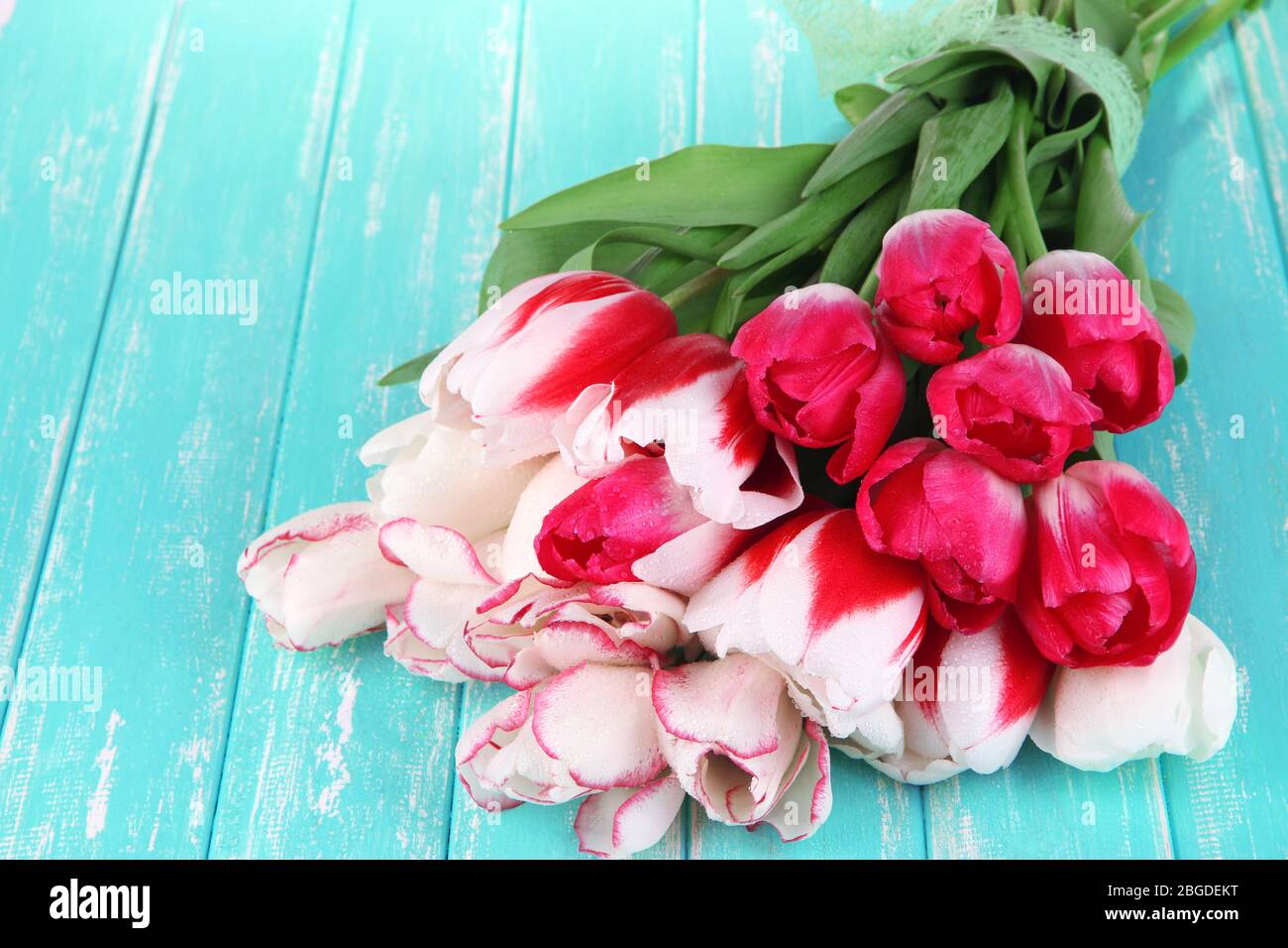 Beautiful tulips on color wooden background Stock Photo - Alamy