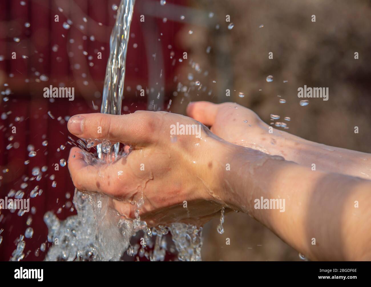 male hands under a stream of water Stock Photo - Alamy