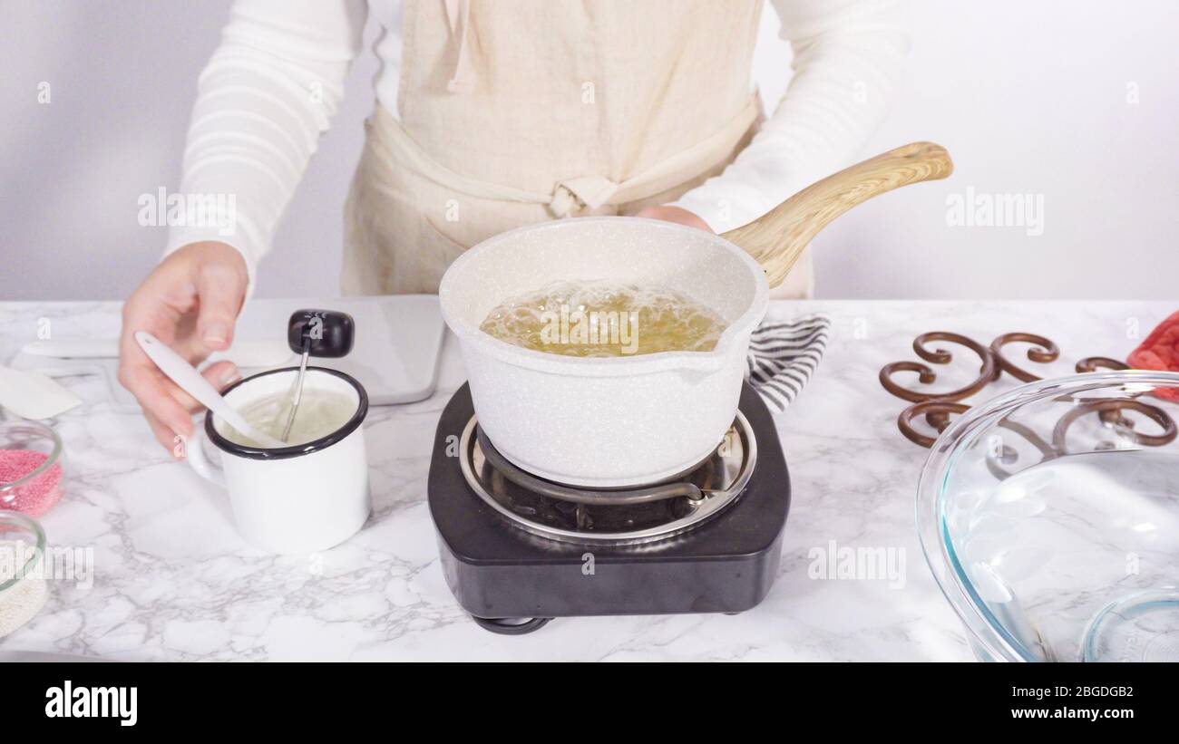 Step by step. Caramelizing sugar in a small cooking pot over the small ...