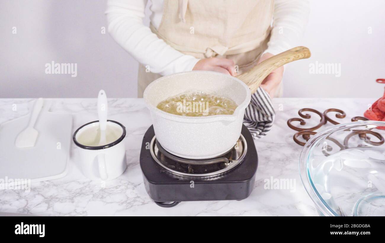 Step by step. Caramelizing sugar in a small cooking pot over the small ...