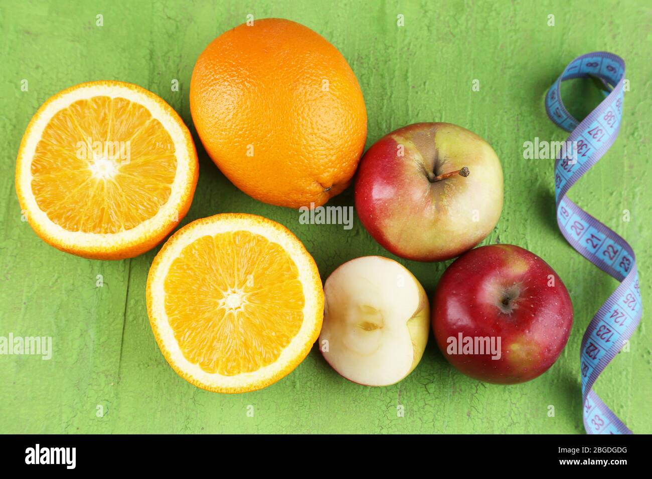 Fruits with measuring tape on wooden background Stock Photo - Alamy