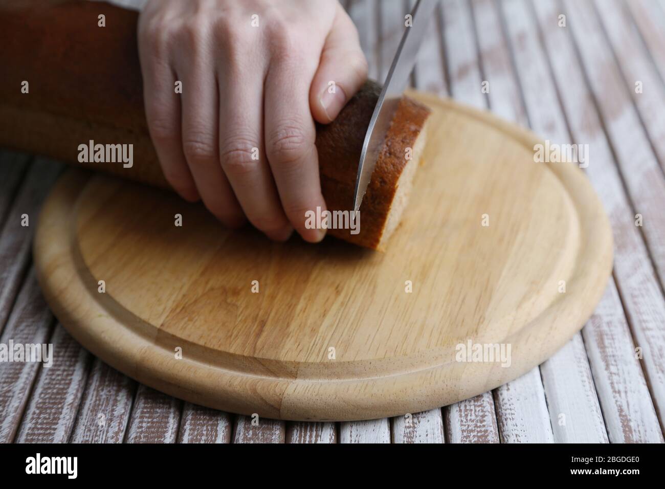 Hands cutting bread hi-res stock photography and images - Alamy