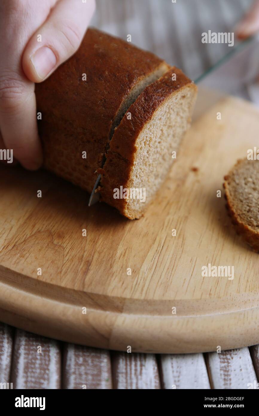 Hands cutting bread hi-res stock photography and images - Alamy