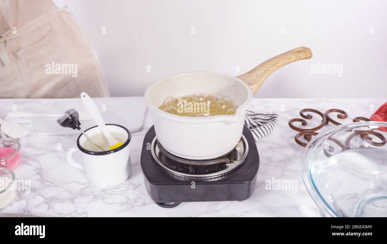 Step by step. Caramelizing sugar in a small cooking pot over the small ...