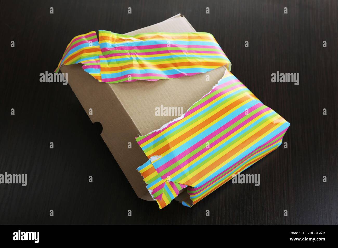 Unwrapped and opened gift box on wooden background Stock Photo - Alamy