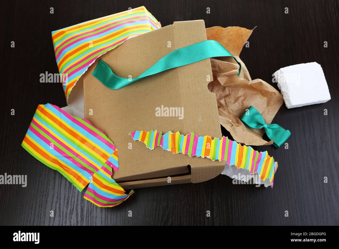 Unwrapped and opened gift box on wooden background Stock Photo - Alamy