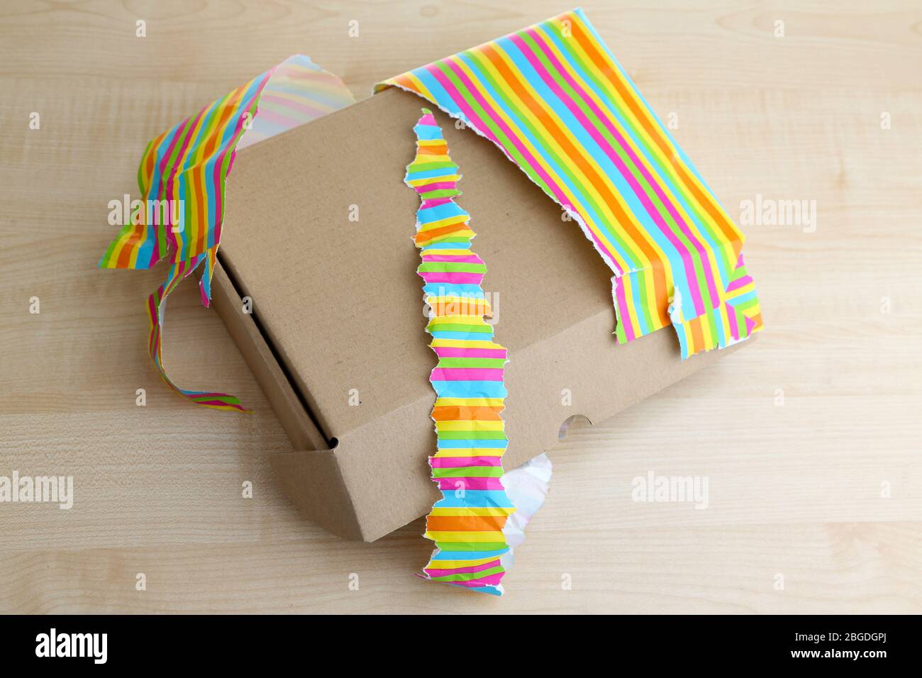 Unwrapped and opened gift box on wooden background Stock Photo - Alamy