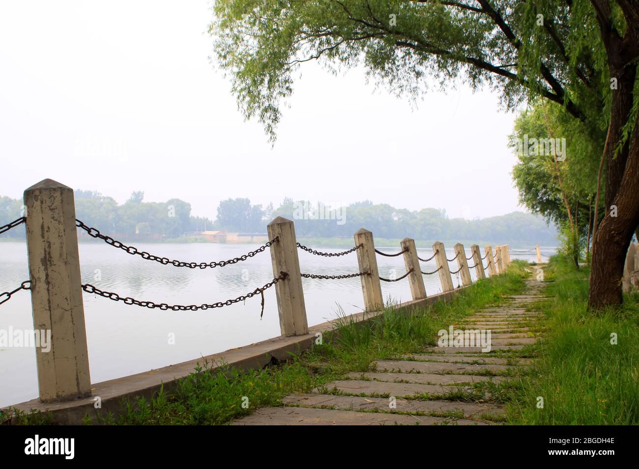 railing and path in the lawn in a park Stock Photo - Alamy