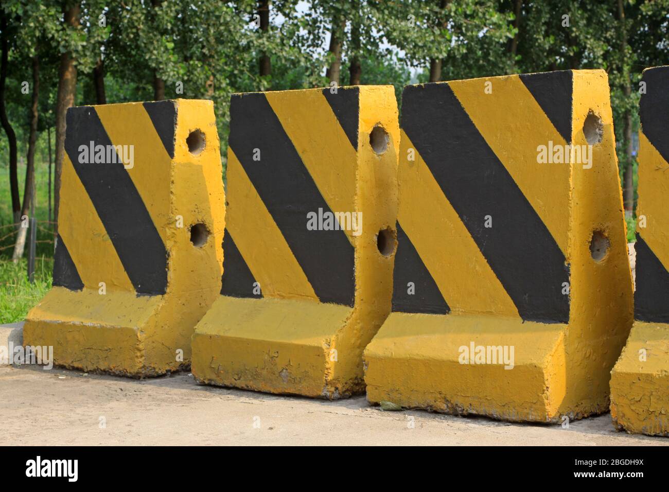 chromatic cement traffic isolation pier in road Stock Photo - Alamy