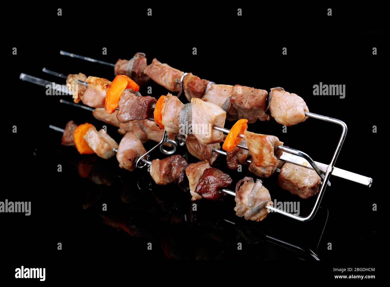 Pork kebab on grill on black background Stock Photo - Alamy