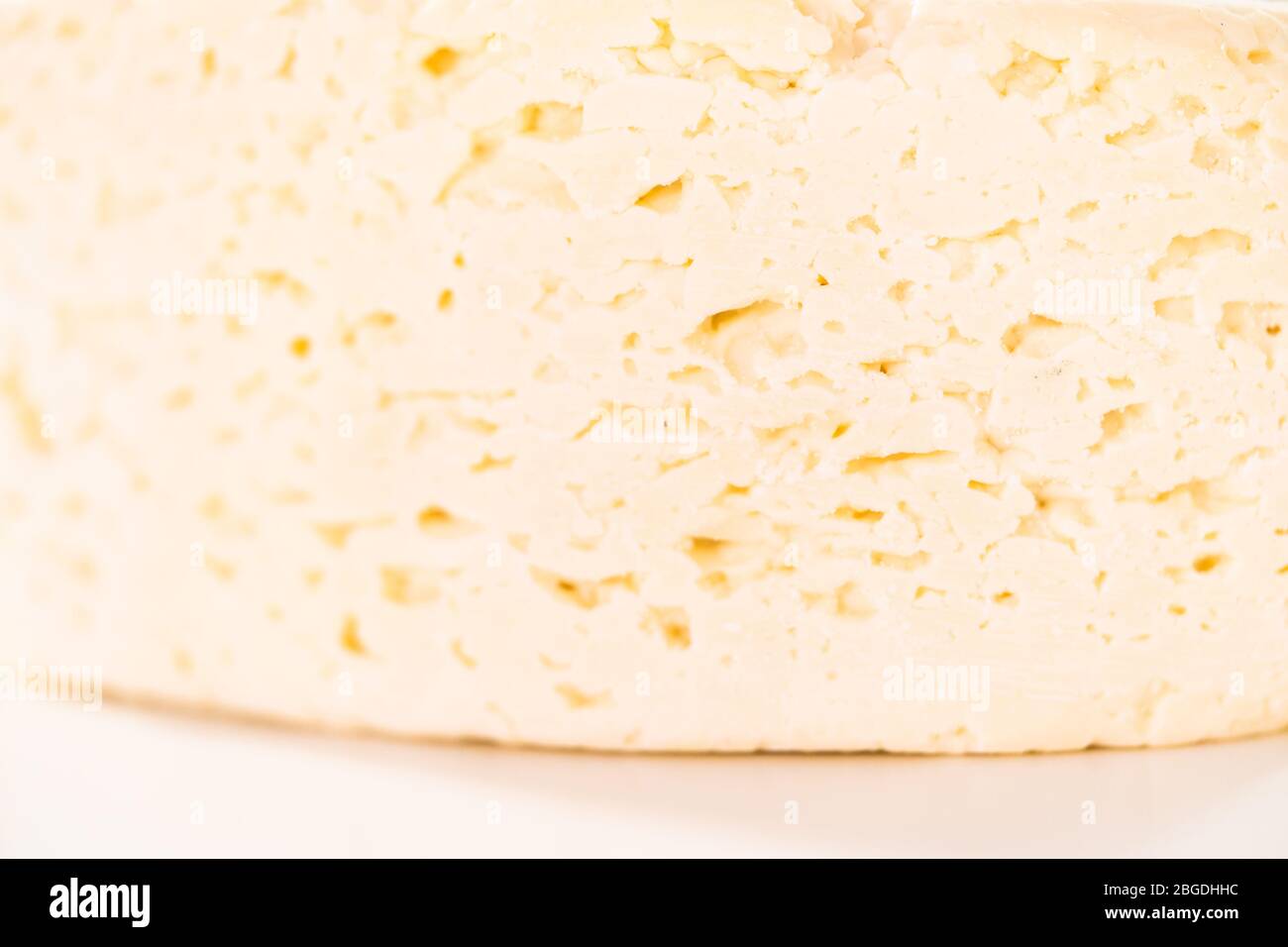 Large slice of blue cheese on a white background Stock Photo - Alamy