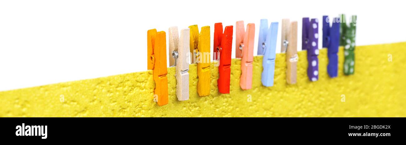 Colorful wooden pins with paper, isolated on white Stock Photo - Alamy