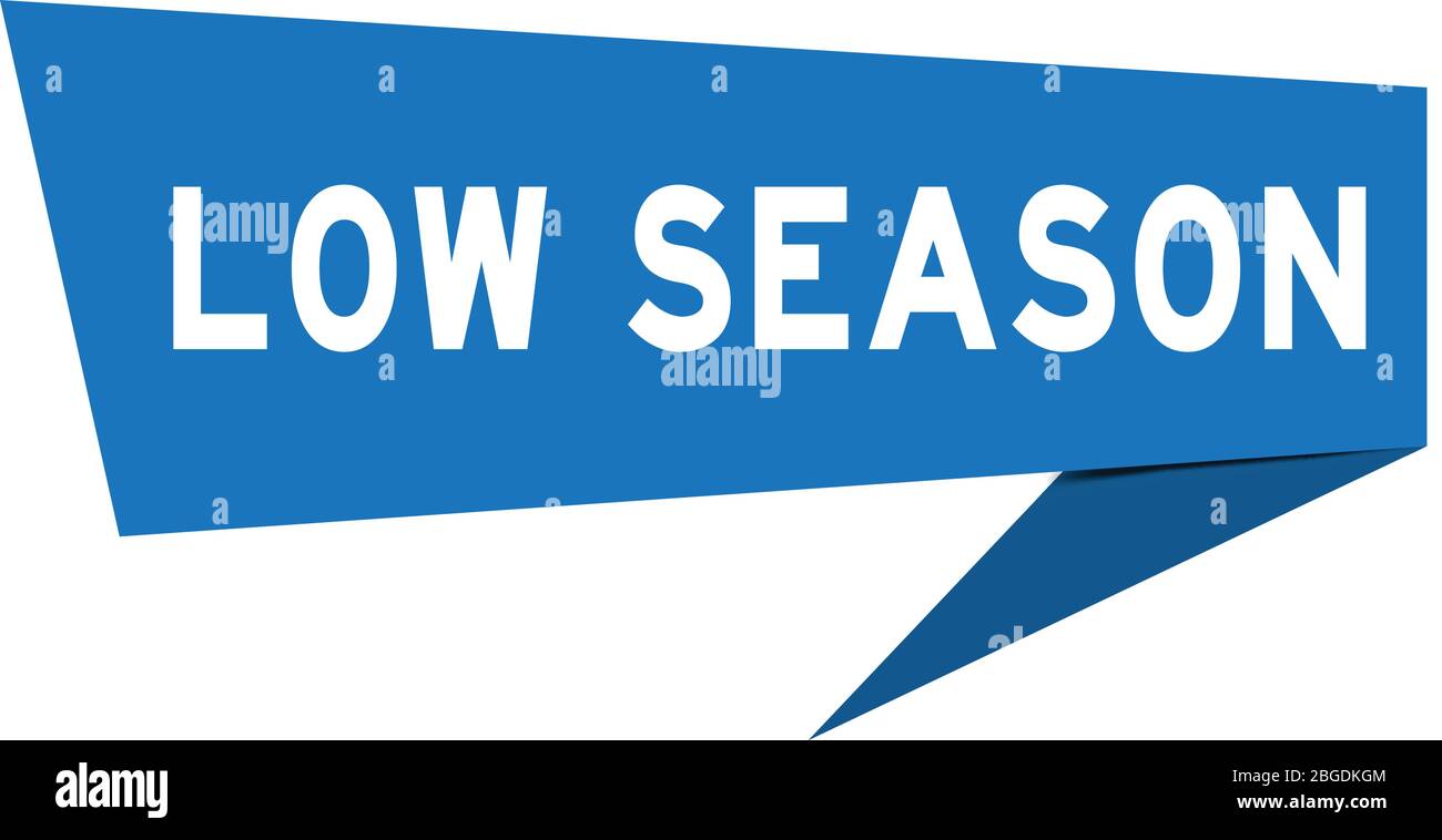 Blue paper speech banner with word low season on white background ...