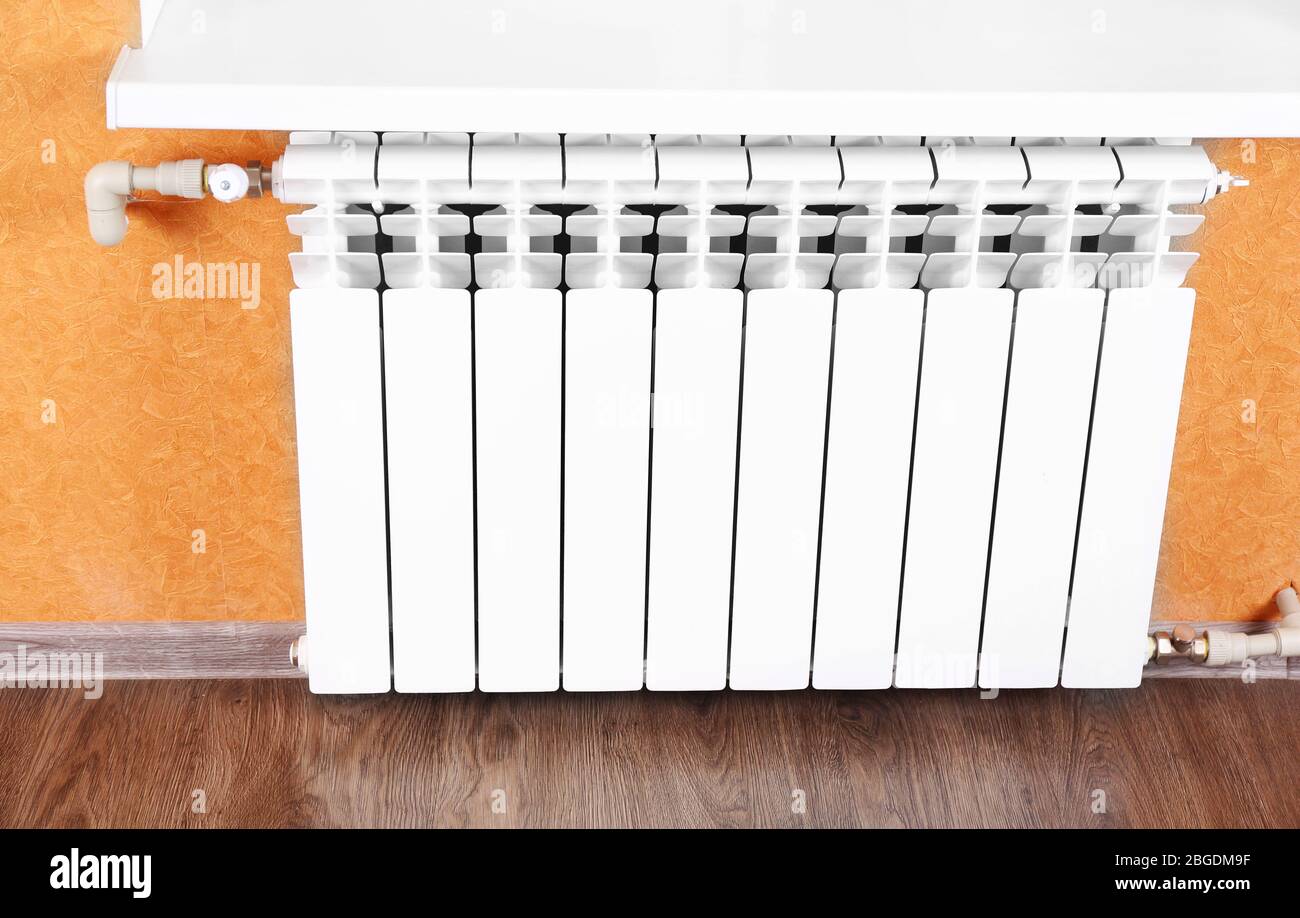 Heating radiator in room Stock Photo - Alamy