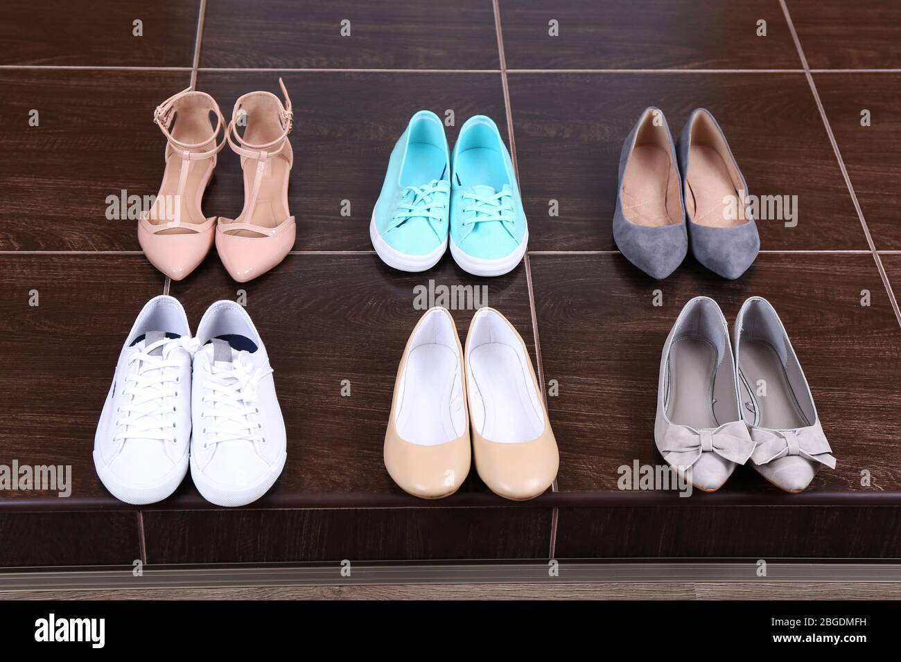 Different shoes on floor Stock Photo - Alamy