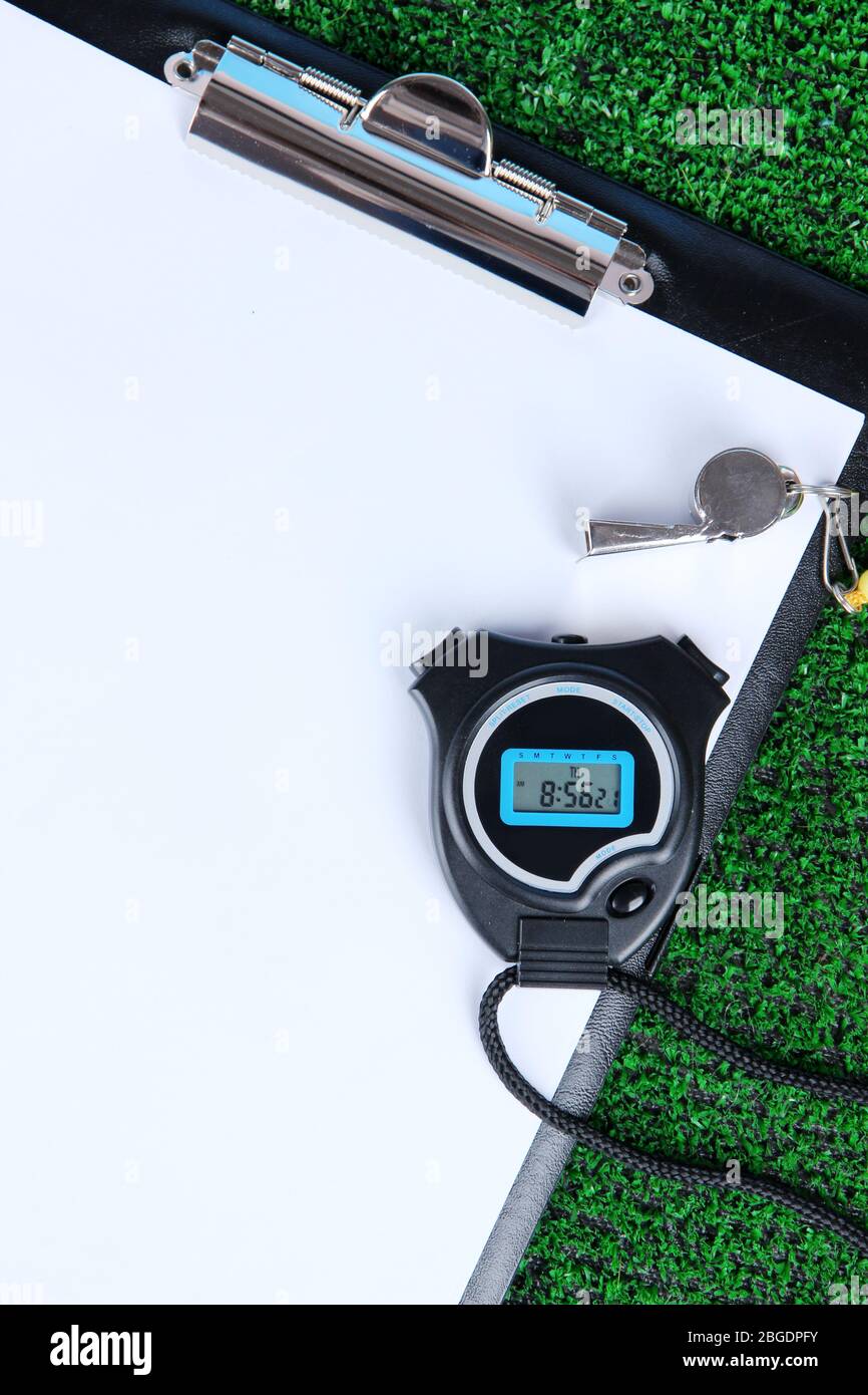 Sheet of paper, stopwatch and whistle on grass close-up Stock Photo - Alamy