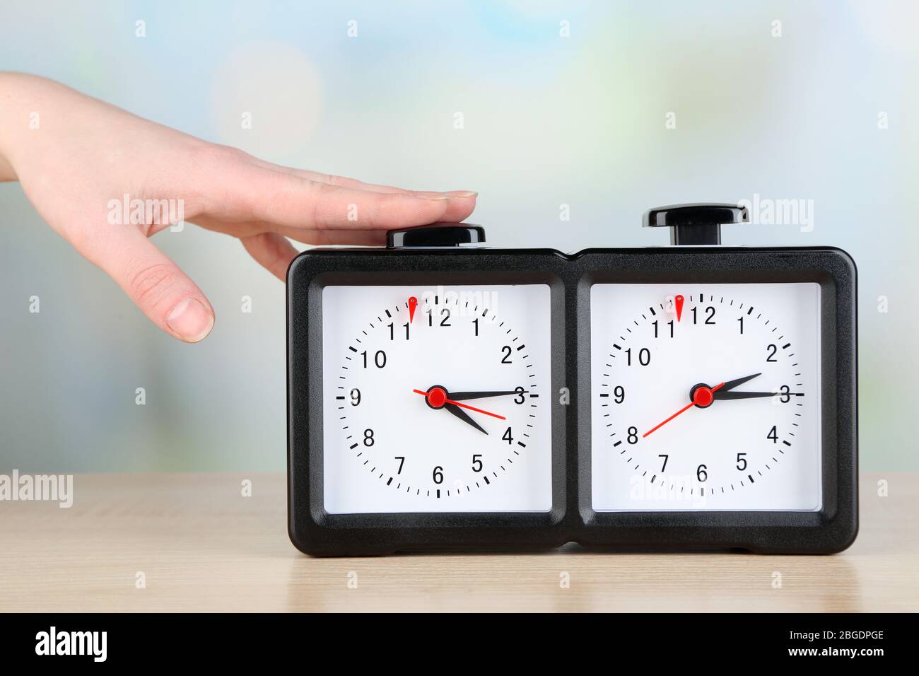 Hand pushing chess clock, close up Stock Photo - Alamy