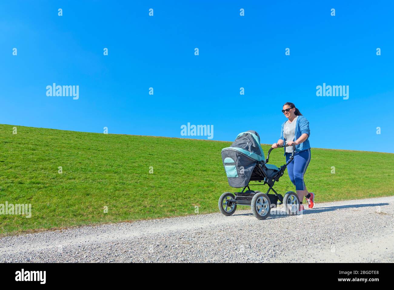 Mother and baby pram park walking hi-res stock photography and images ...