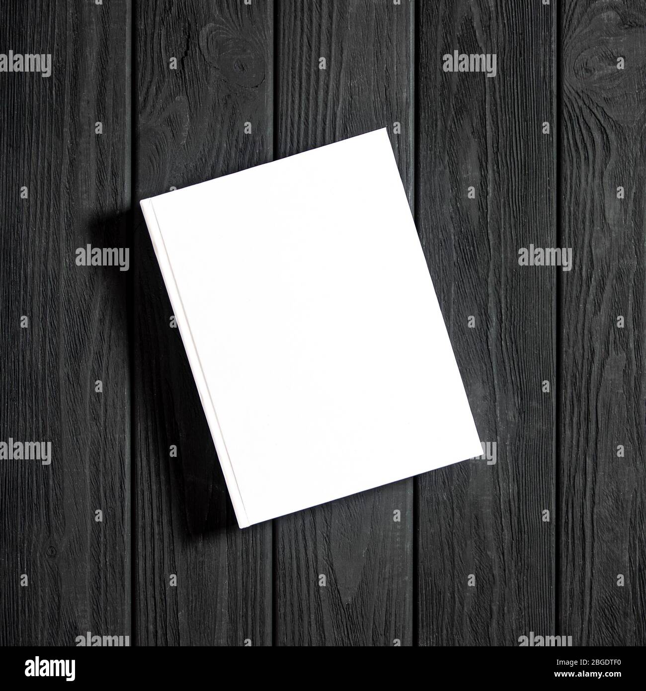 Mockup of closed blank square book at white textured paper Stock Photo ...